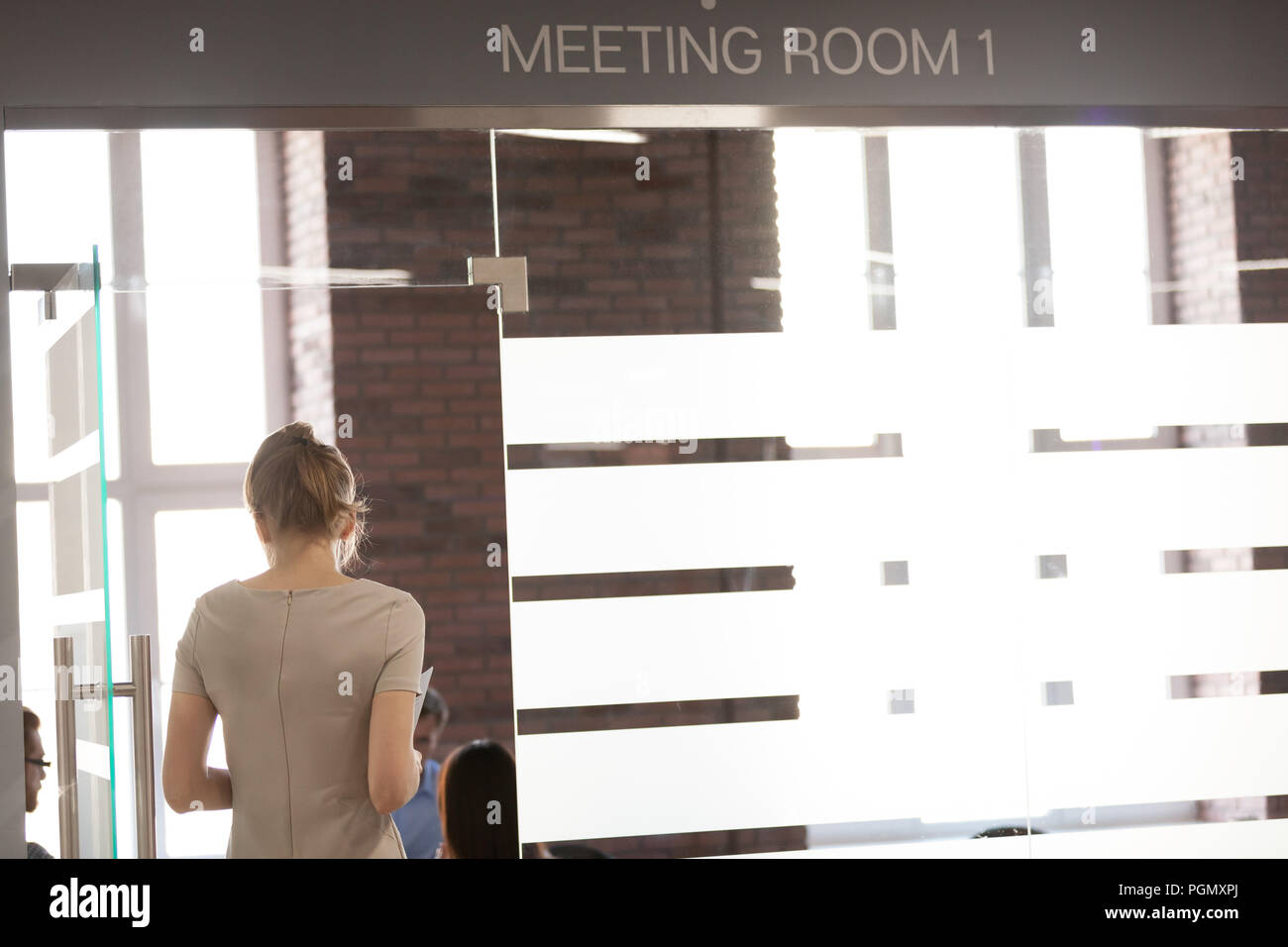Female employee enter meeting room ready for presentation Stock Photo ...