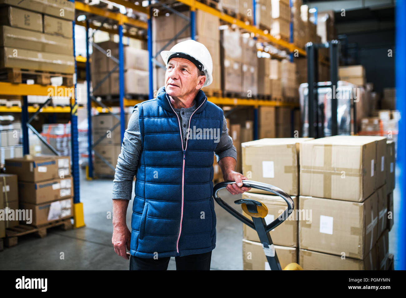 Warehouse pulling pallet truck boxes hi-res stock photography and ...