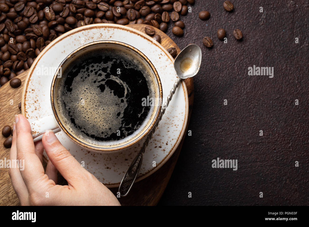 Close-up of a Cup of black coffee and coffee beans on a dark background ...