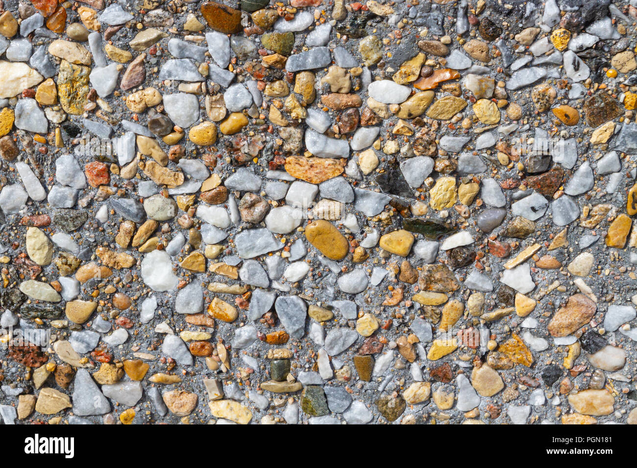 Wall of small colored stone made of cement Stock Photo - Alamy