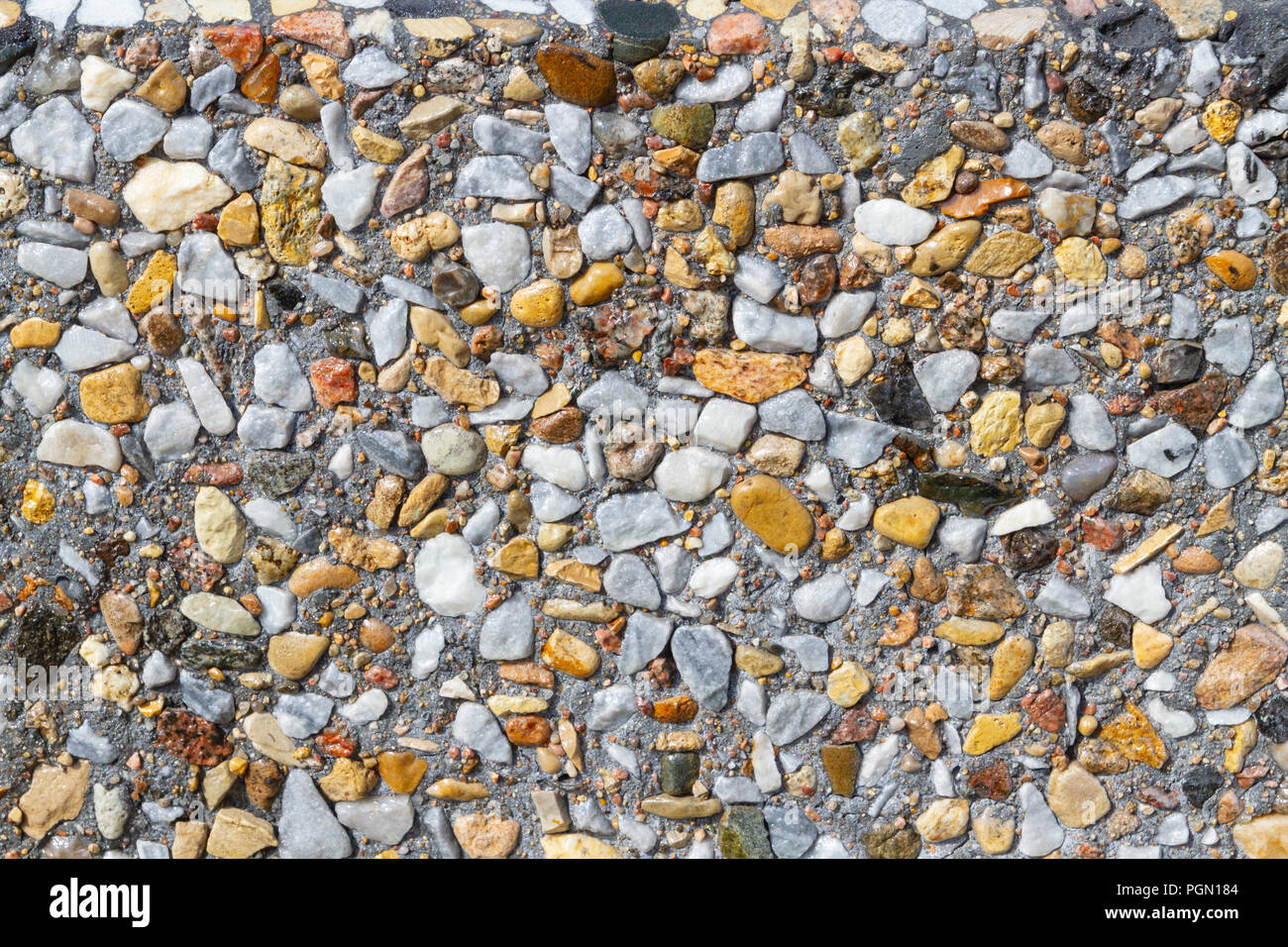 Wall of small colored stone made of cement Stock Photo - Alamy