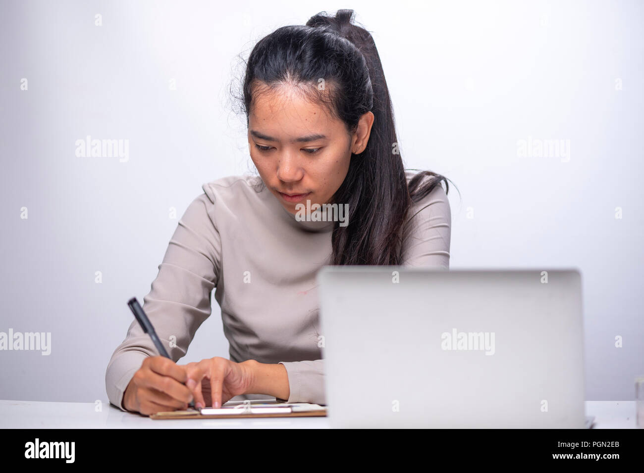 Doctor working with laptop computer and writing on paperwork. Hospital ...