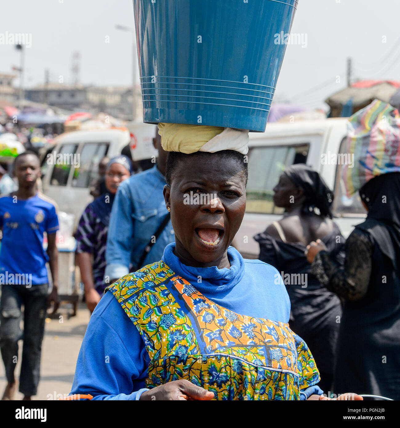 KUMASI, GHANA - JAN 15, 2017: Unidentified Ghanaian woman carries a ...
