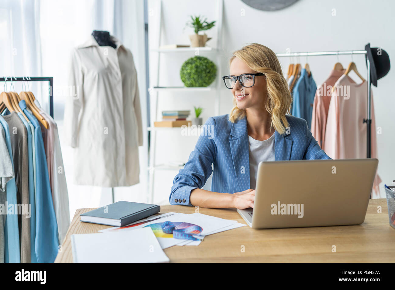 Fashion designer working on her designs in the studio Stock Photo - Alamy