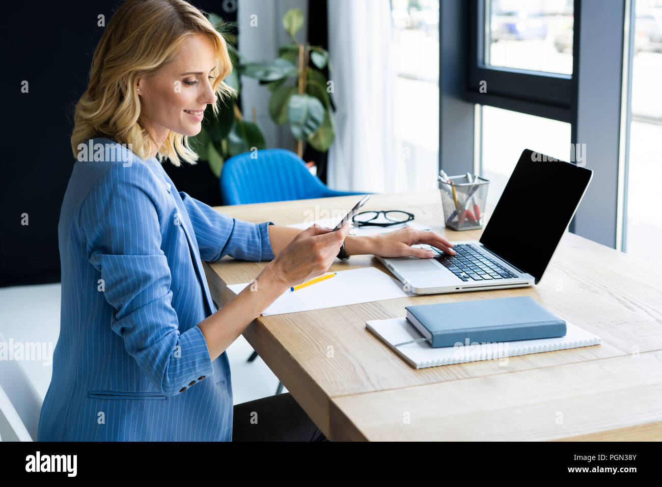 Portrait of a serious businesswoman using laptop in office Stock Photo ...