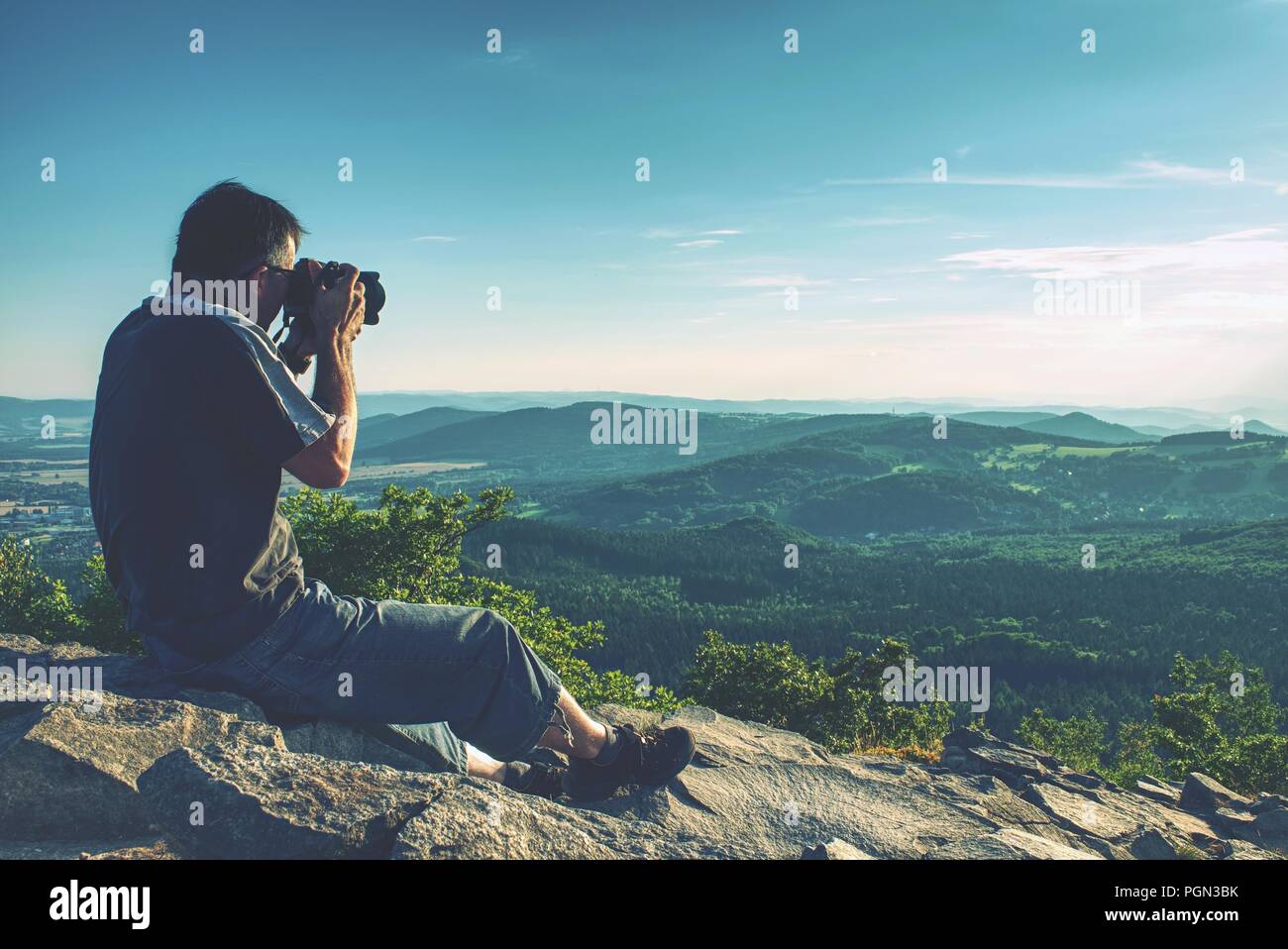 Photographer taking authentic outdoor photos in autumn landscape by big ...