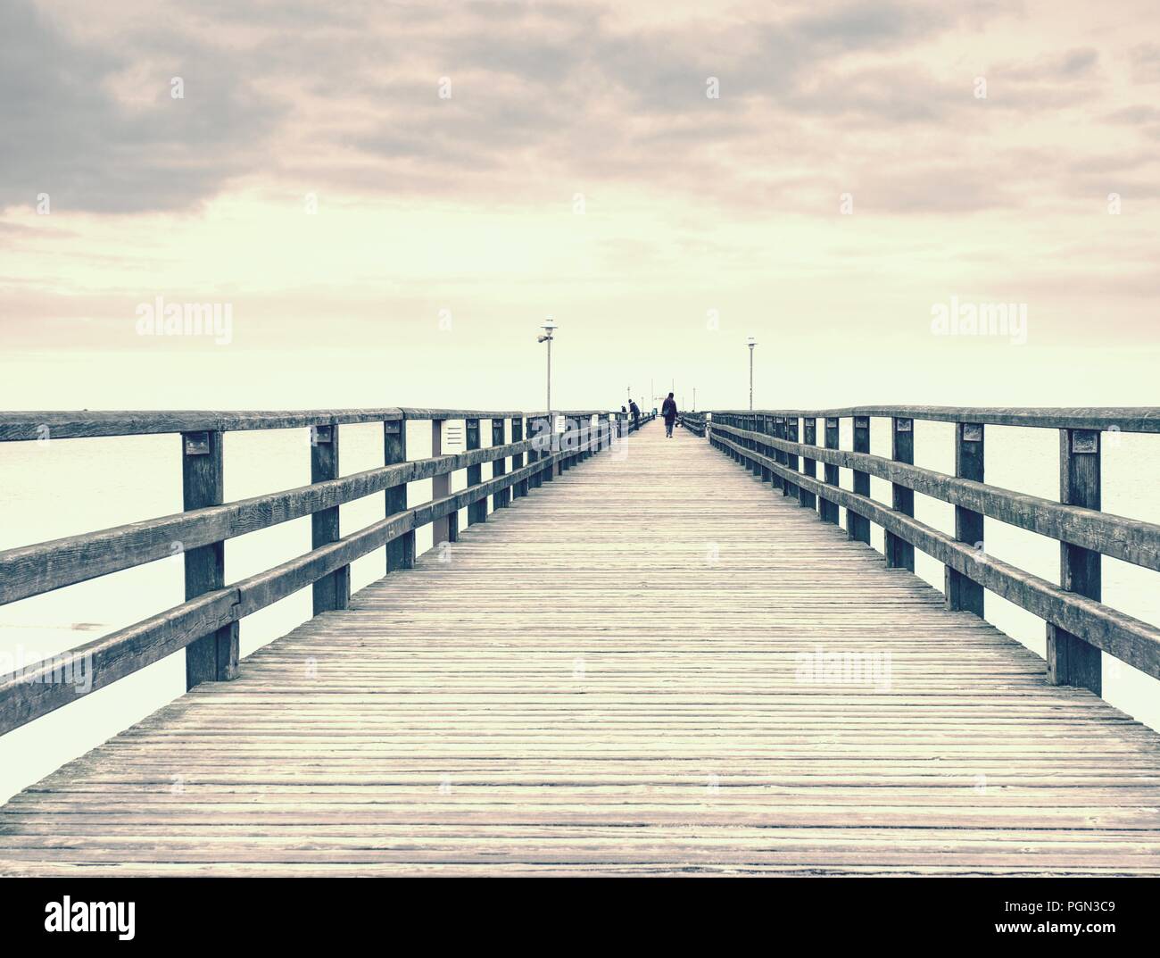 Wooden bridge pier leading to summer sea with blue sky. Island famous ...