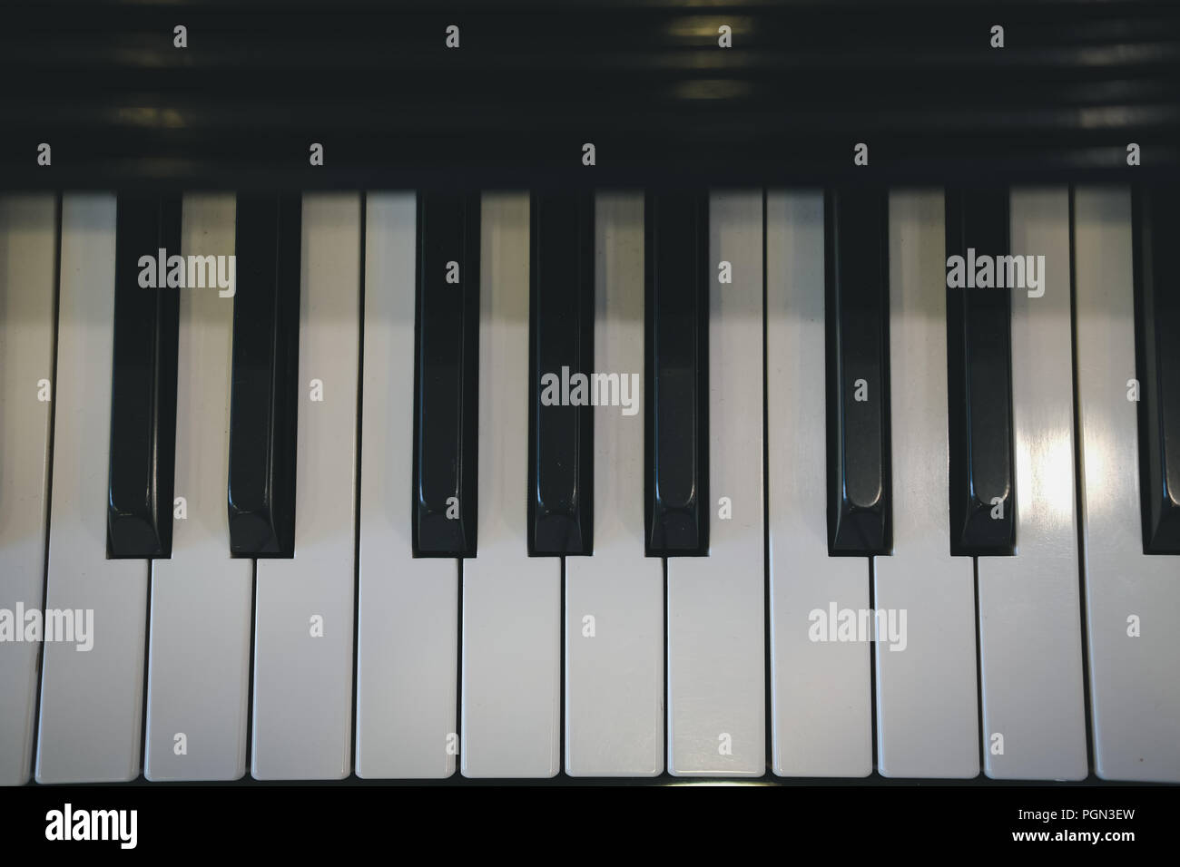 piano keyboard with glossy black & white keys. classic music instrument ...