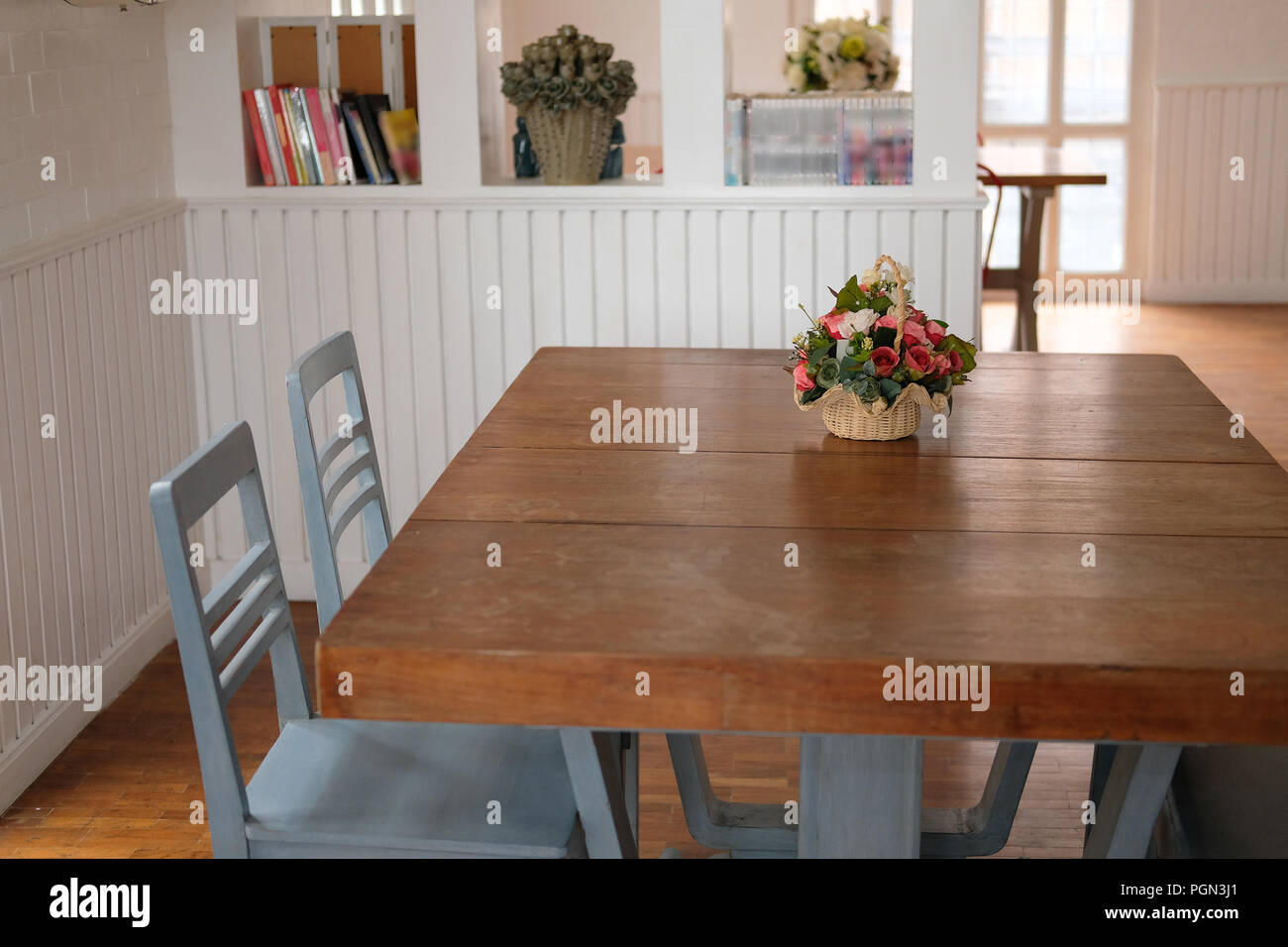 wood table & blue chair set in cozy dining room interior Stock Photo ...