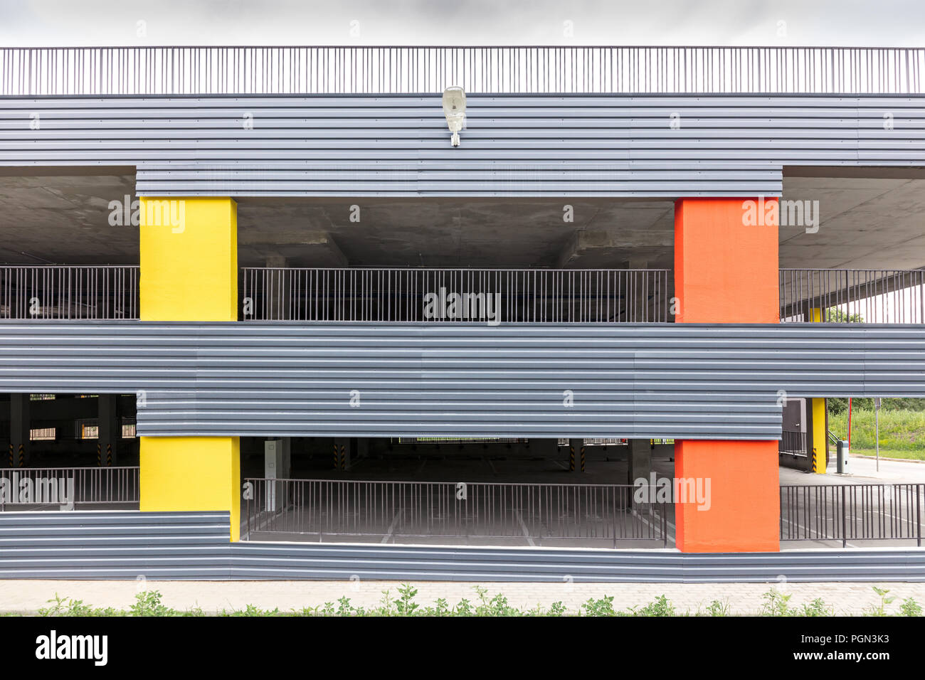 side view of newly built modern car park. multilevel garage building ...