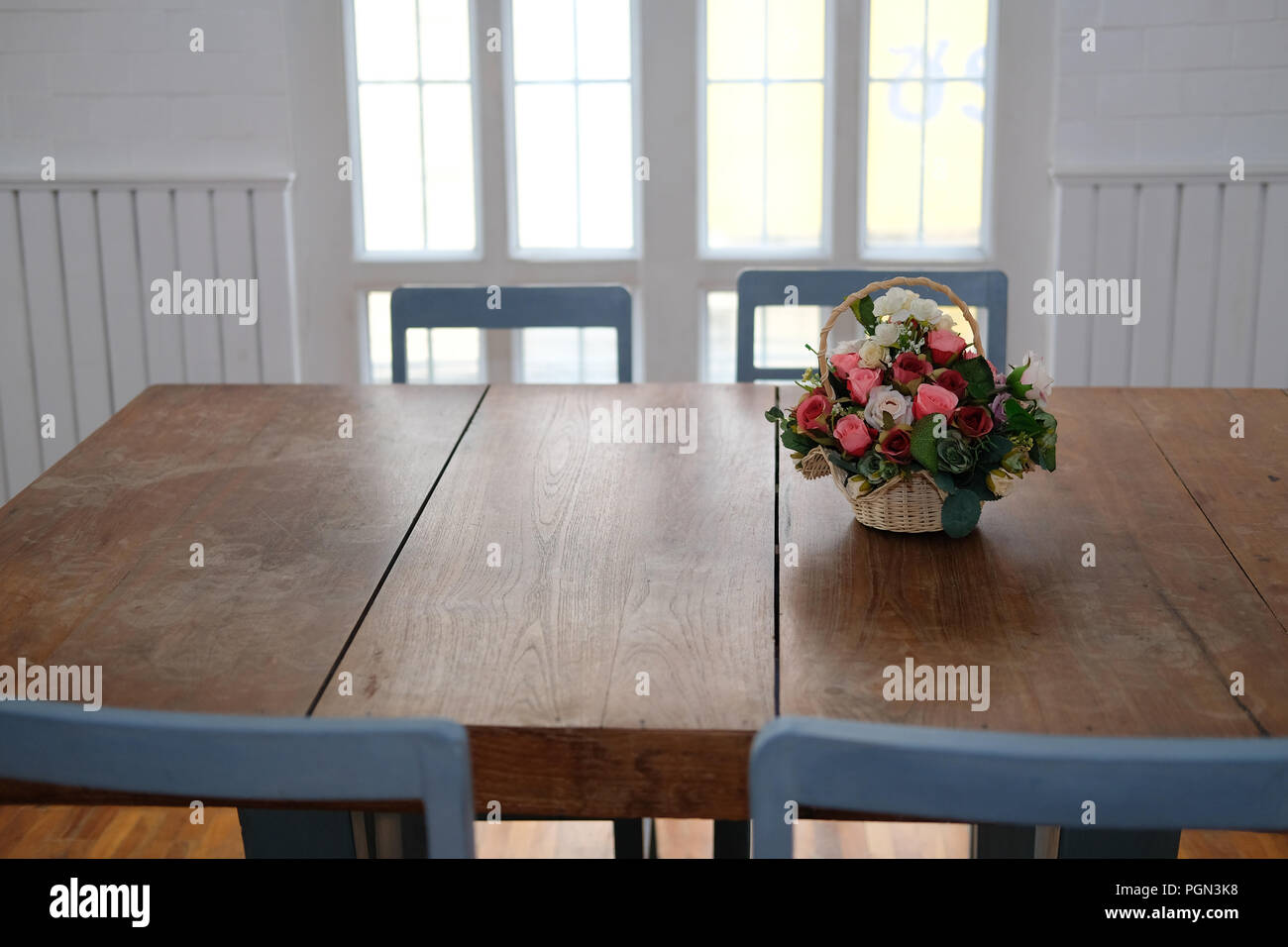 wood table & blue chair set in cozy dining room interior Stock Photo ...