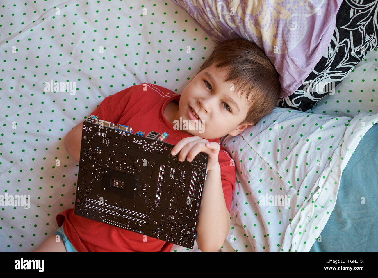 Little boy is playing with a circuit board Stock Photo - Alamy