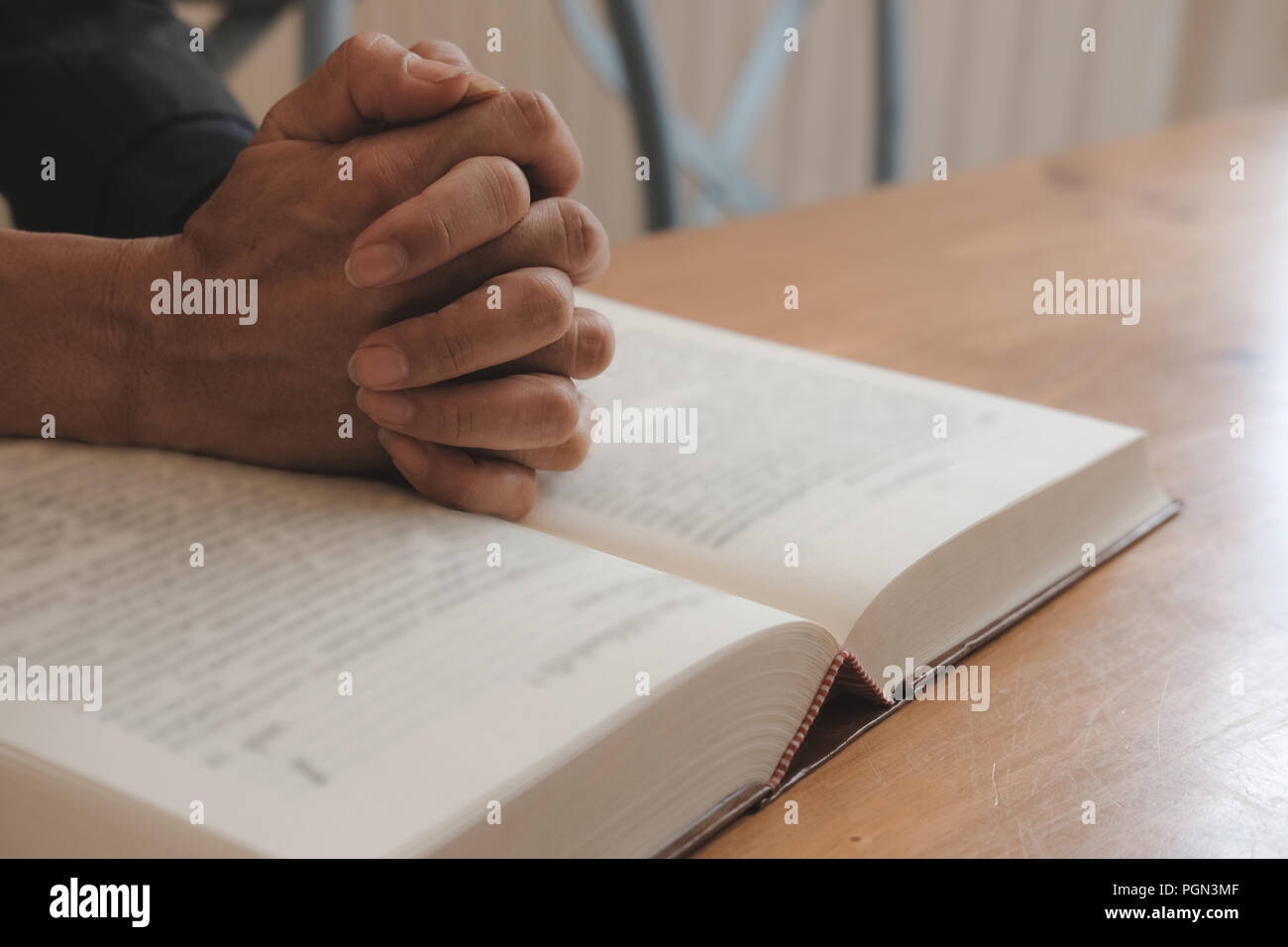 man's hand praying on opening holy bible. faith, religion concept Stock ...