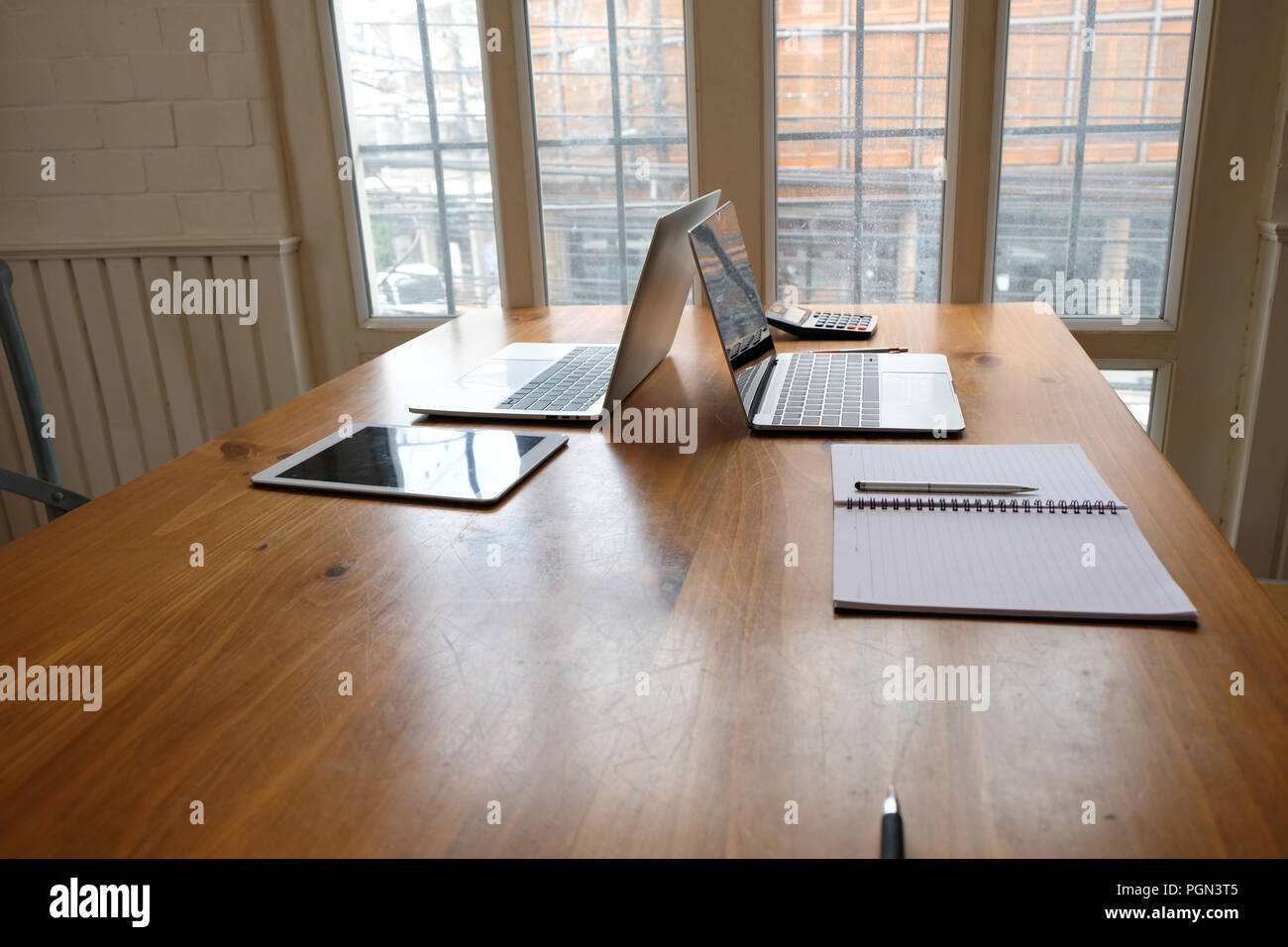 tablet, computer laptop on wood office desk near window. wokring space ...
