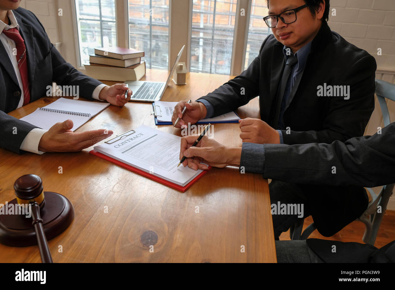 businessman consulting lawyer & signing contract agreement. judge gavel ...