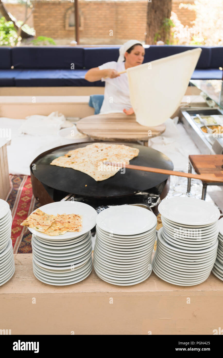 Two Turkish women are sitting and cooking Turkish Gozleme Stock Photo ...