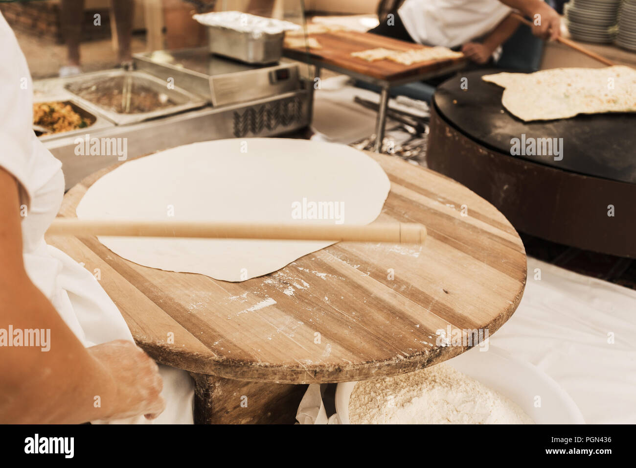 Two Turkish women are sitting and cooking Turkish Gozleme Stock Photo ...