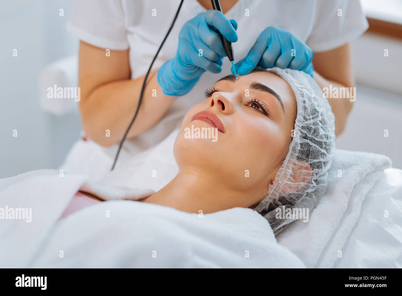 Nice beautiful woman having her mole removed Stock Photo - Alamy