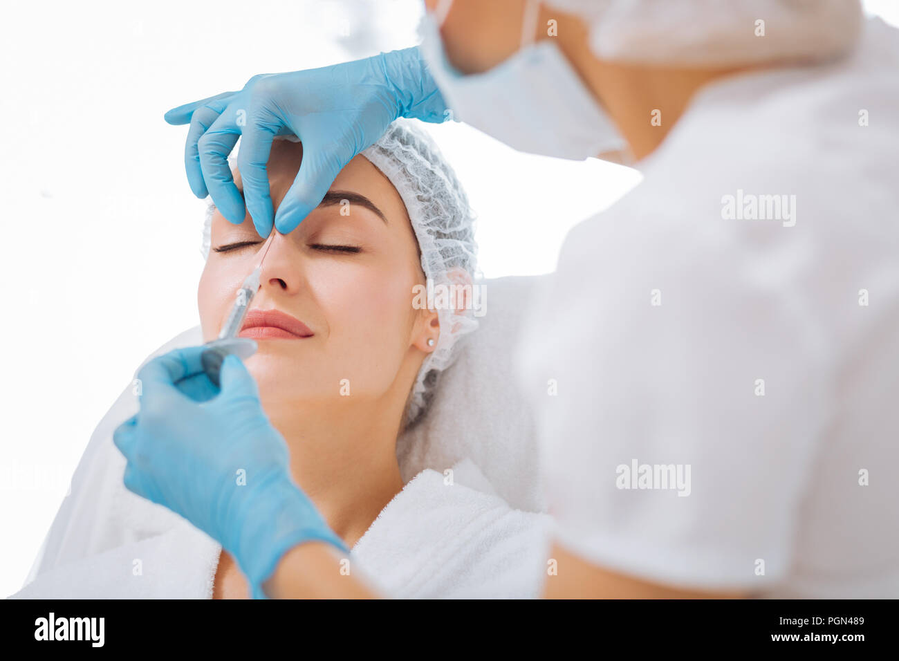 Skilled experienced beautician doing an injection in the nose Stock ...