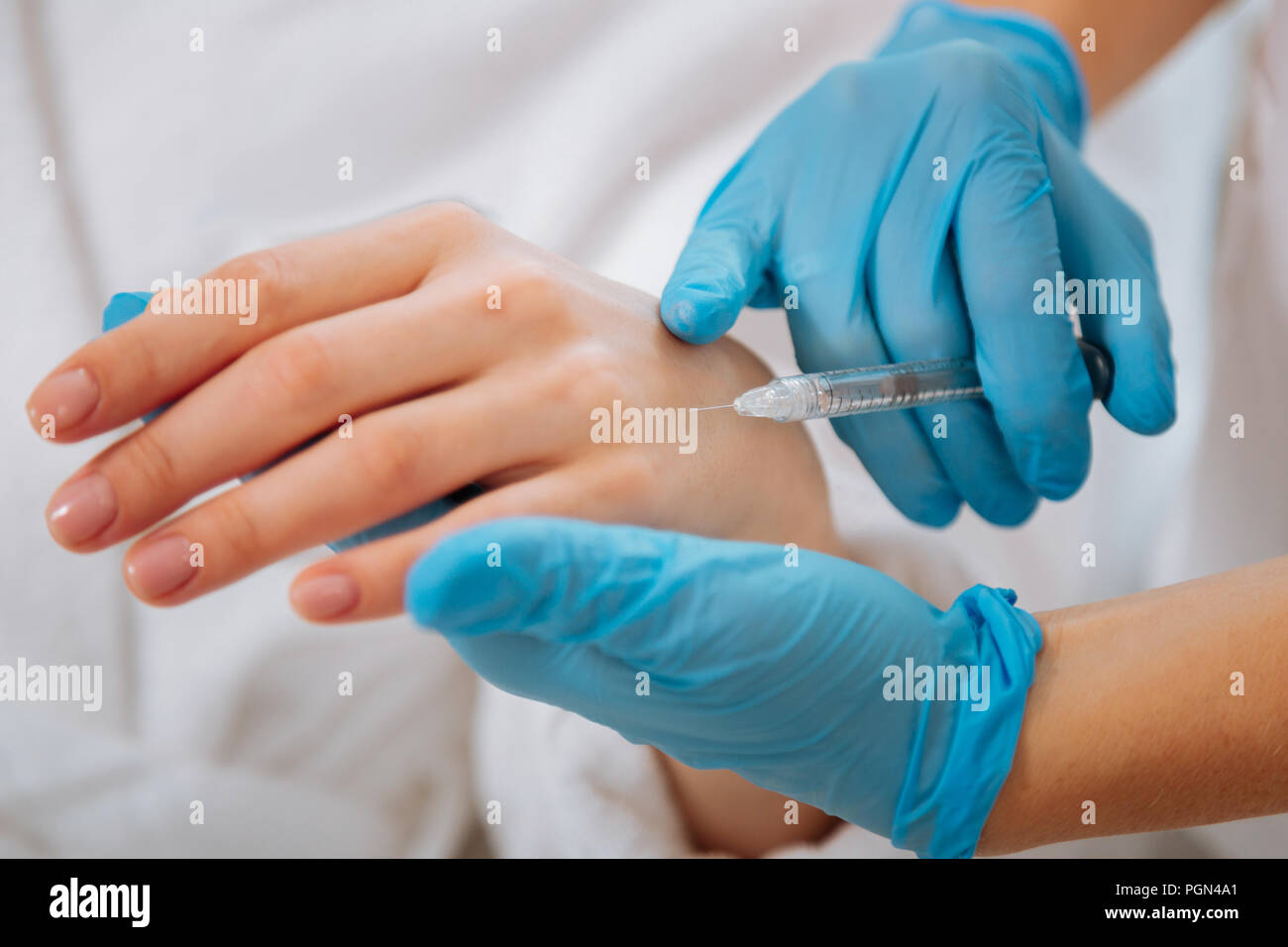 Nice skilled beautician doing an injection in the hand Stock Photo - Alamy