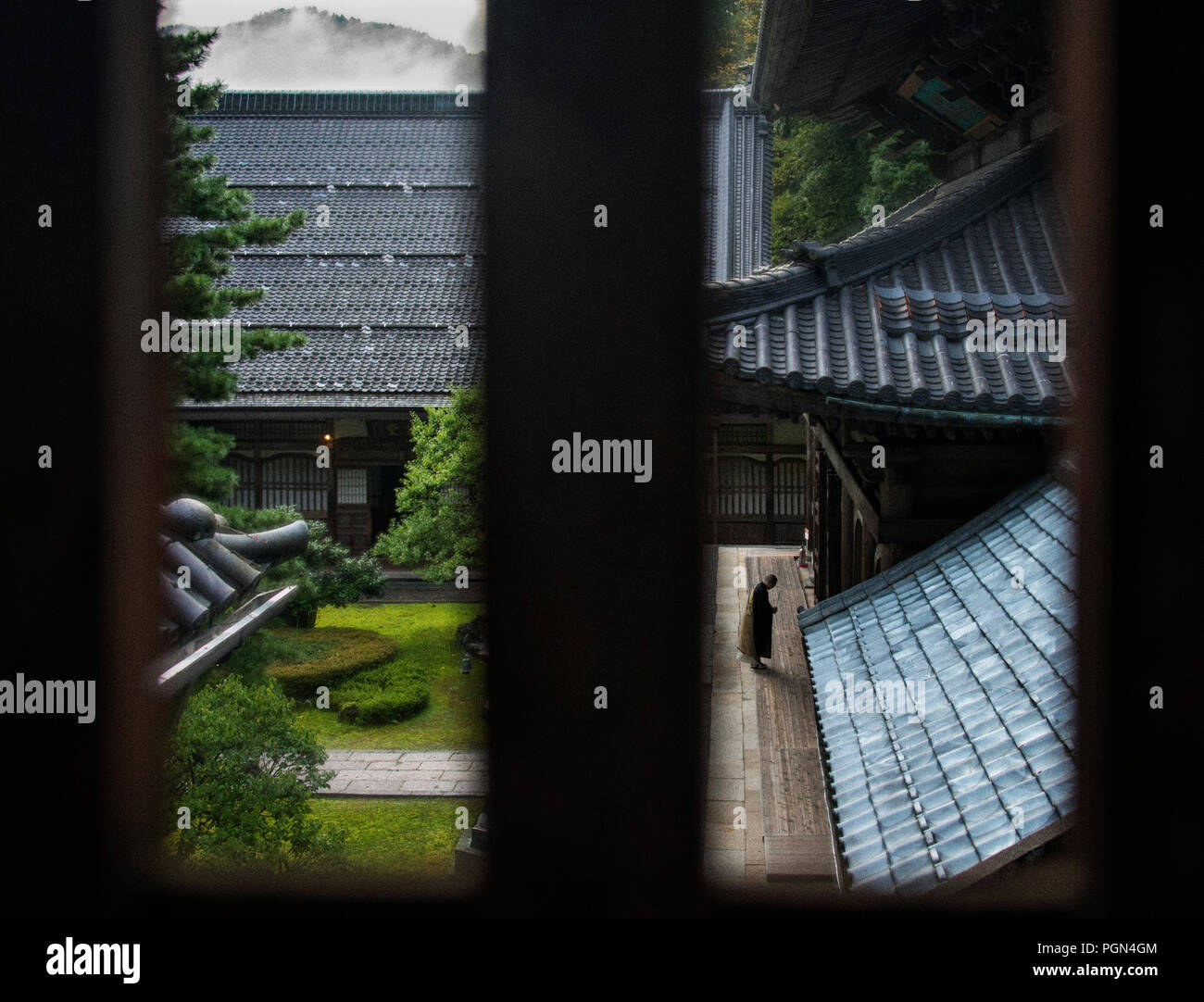A monk bows as he passes in front of the Hatto, or Dharma Hall, inside ...