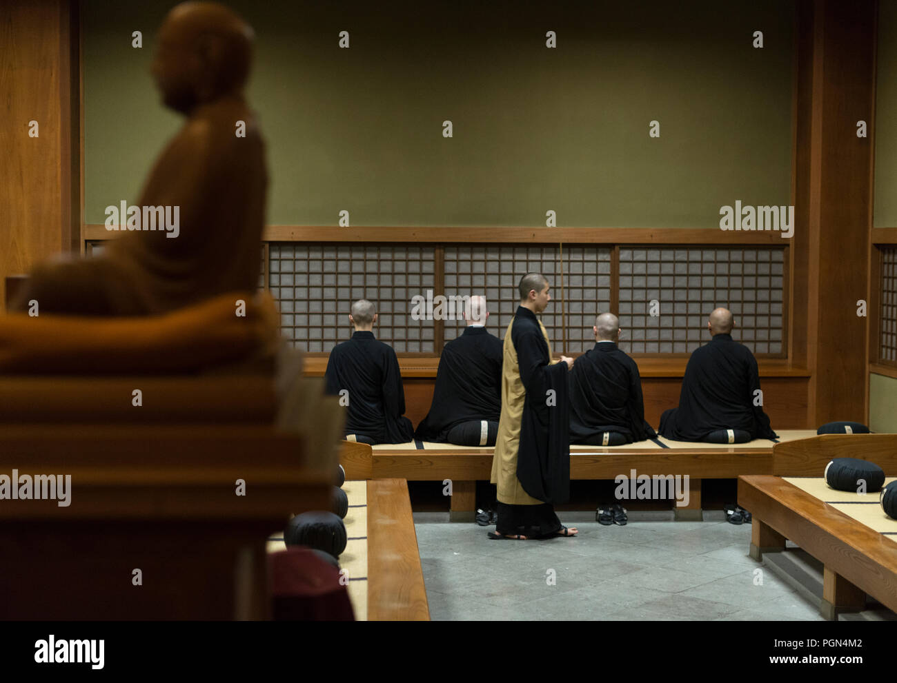 Photo shows priests training in zazen meditation inside the Sodo, or ...
