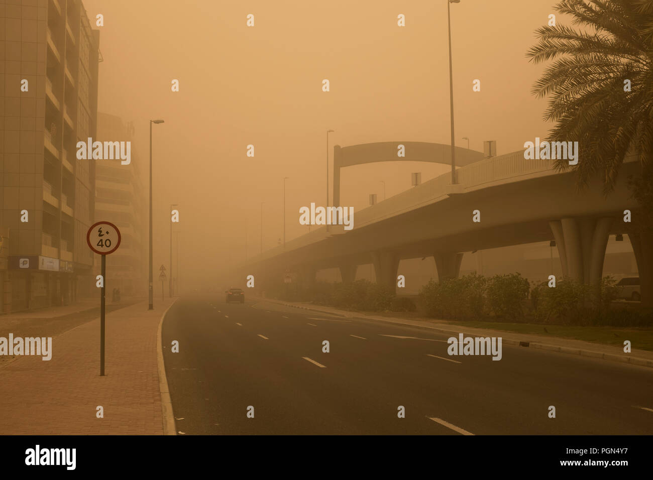 Car driving down a street during a sandstorm in Dubai, United Arab ...