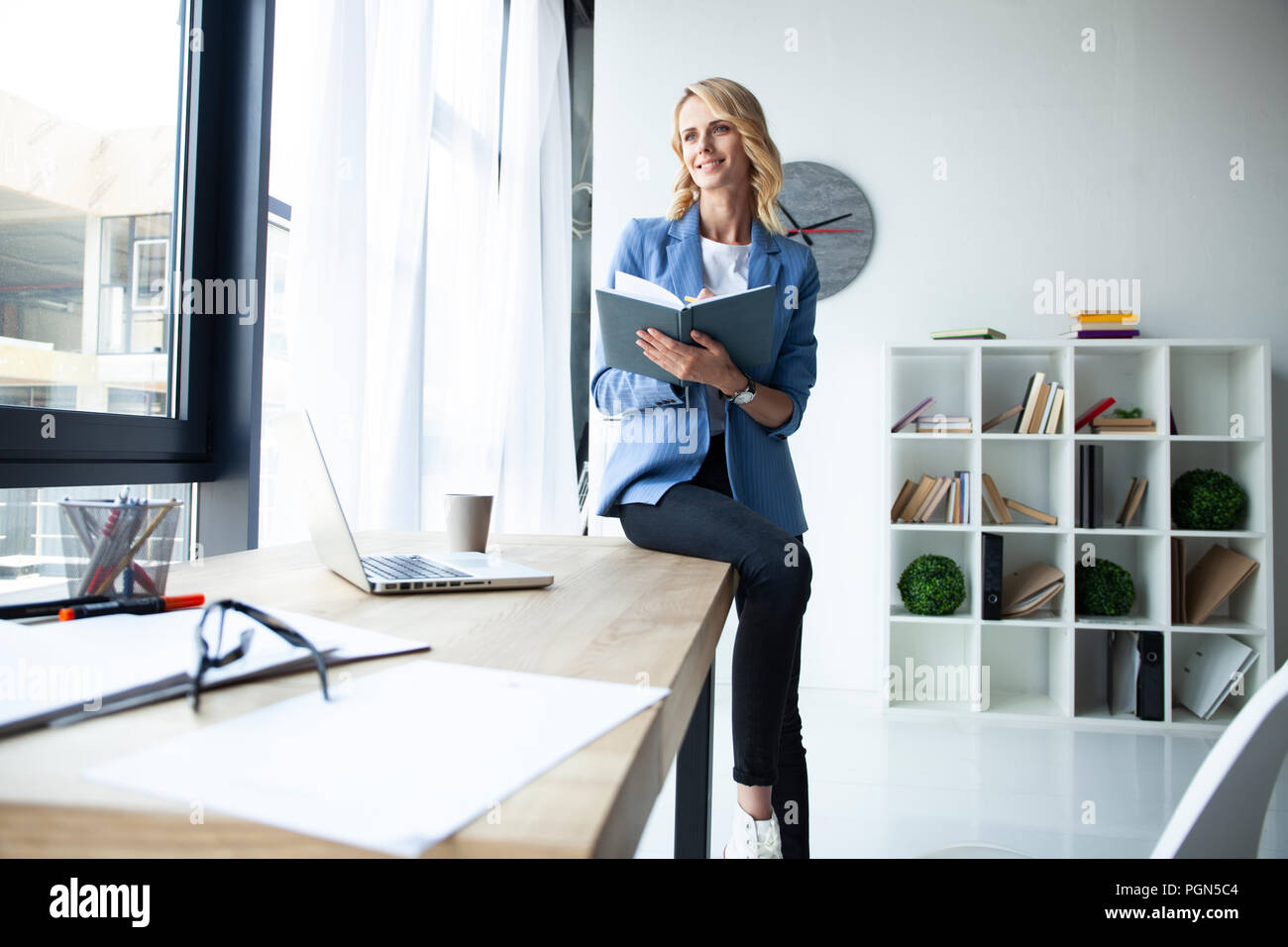 Beautiful business lady smiling while working in office Stock Photo - Alamy