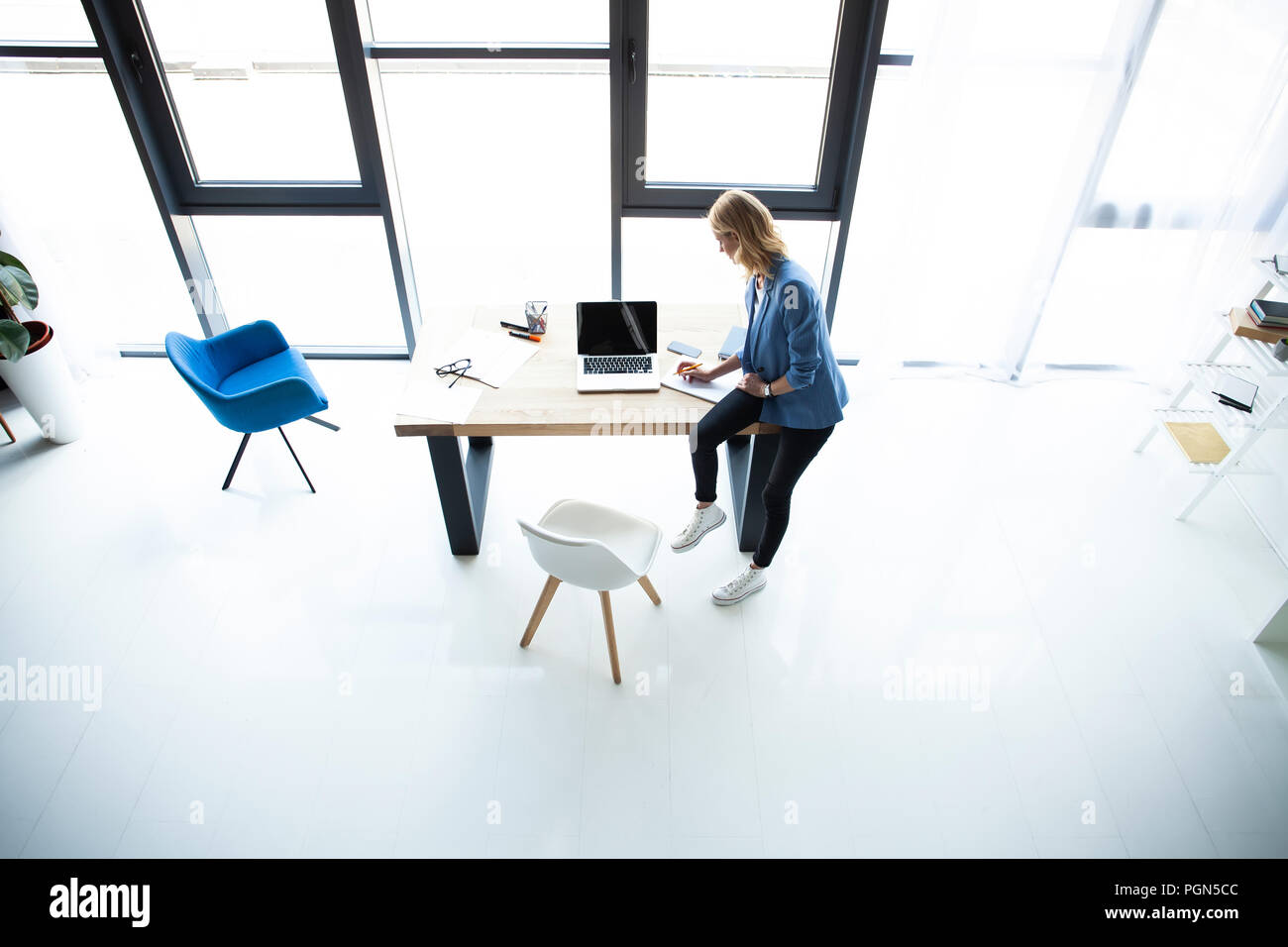Beautiful business lady smiling while working in office Stock Photo - Alamy
