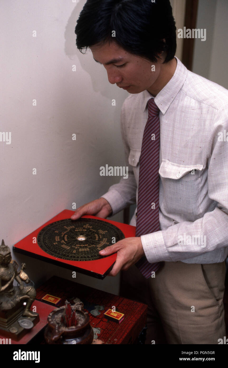 In China a man practises Feng Shui using a Geomancy compass which ...