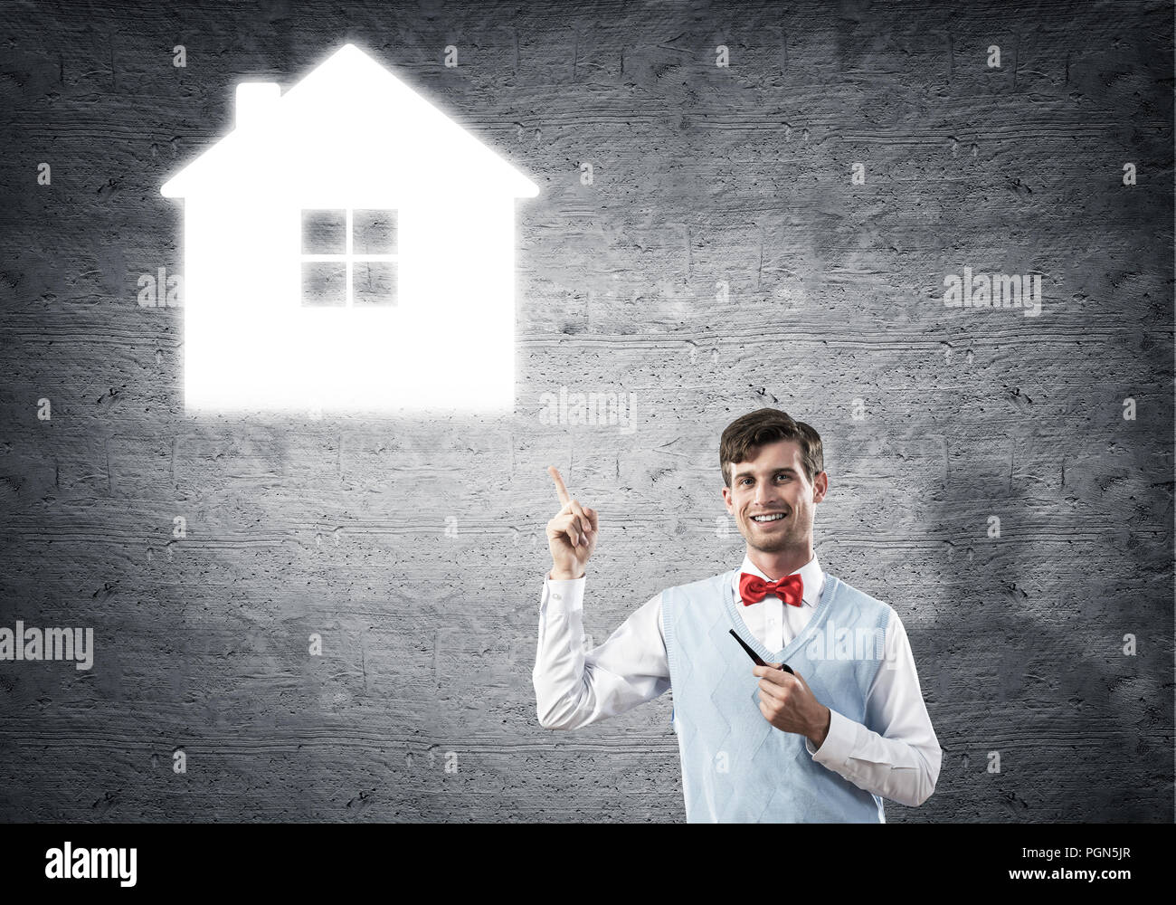 Elegant banker wearing red tie and house sign as banking concept Stock ...