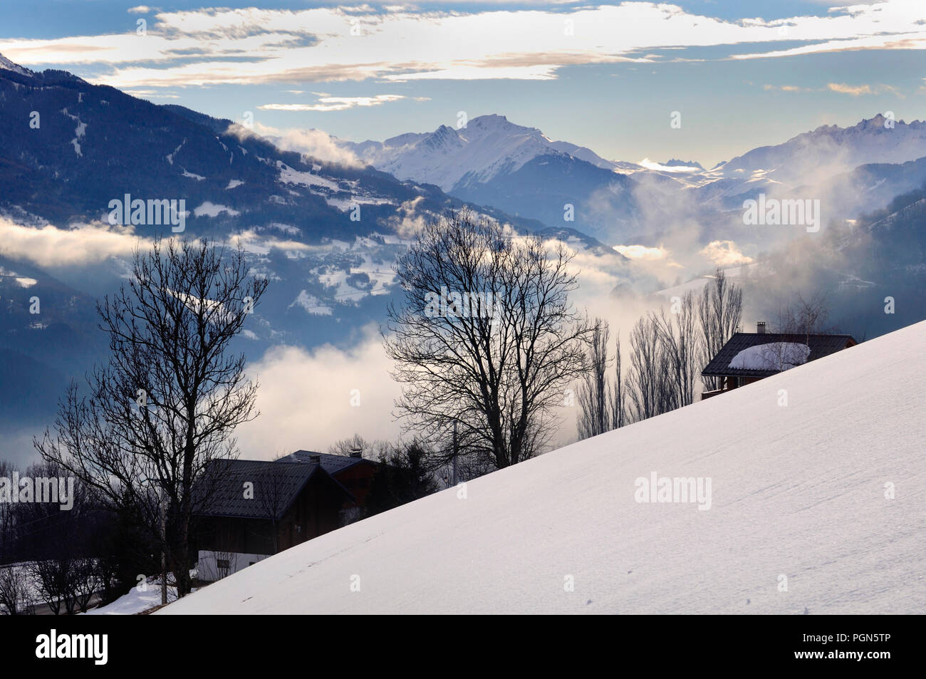 landscape in an alpine snowy and cloudy valley Stock Photo - Alamy