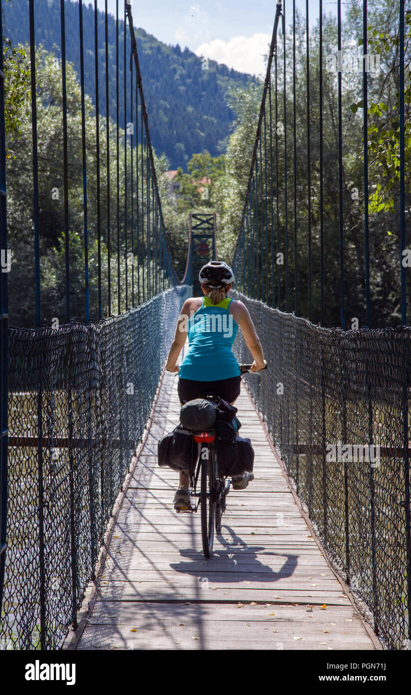 A cyclist crossing the rope bridge Stock Photo - Alamy