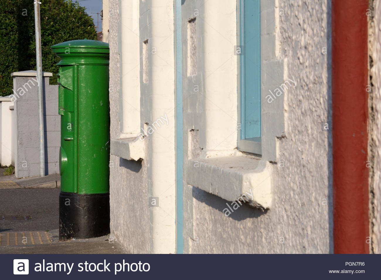 A green irish post box in brilliant sunshine in Tralee County Kerry ...