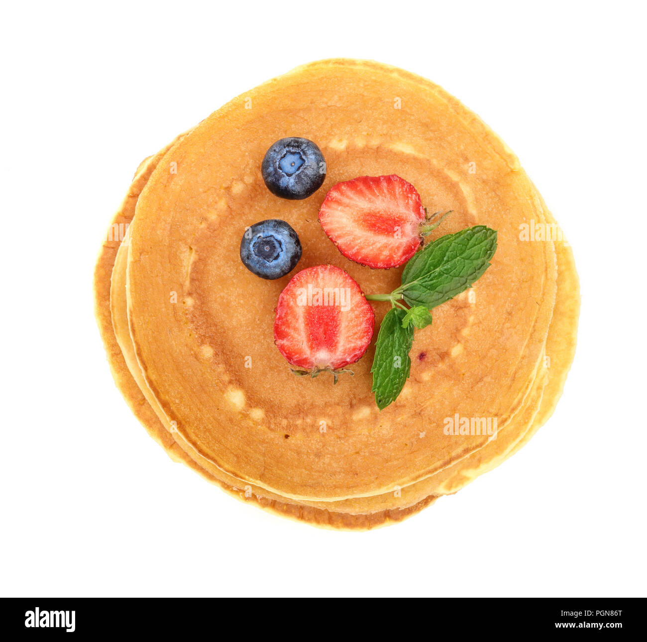 Pancakes stack with strawberry and blueberry isolated on white background. Top view. Flat lay ...