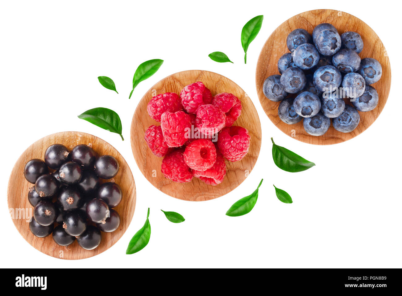 blueberry raspberry black currant in wooden bowl isolated on white ...