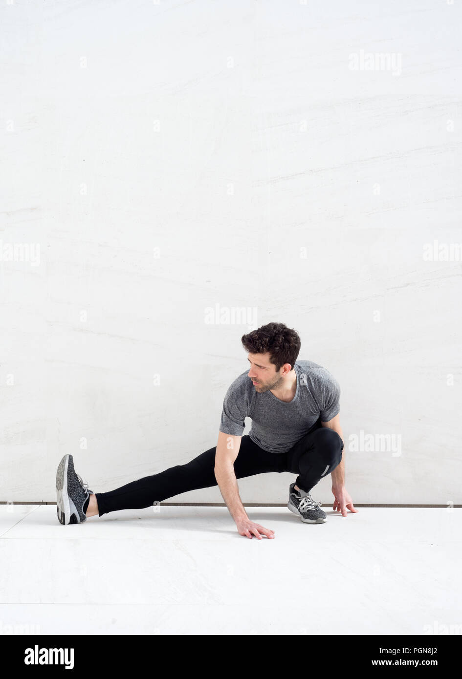 man stretches leg-Space for text Stock Photo - Alamy