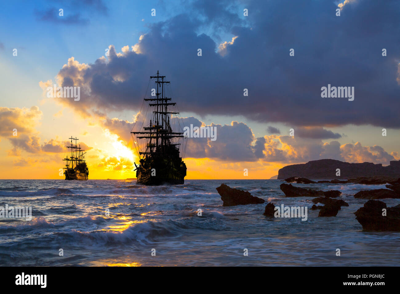 Old ship silhouette in sunset scenery Stock Photo - Alamy