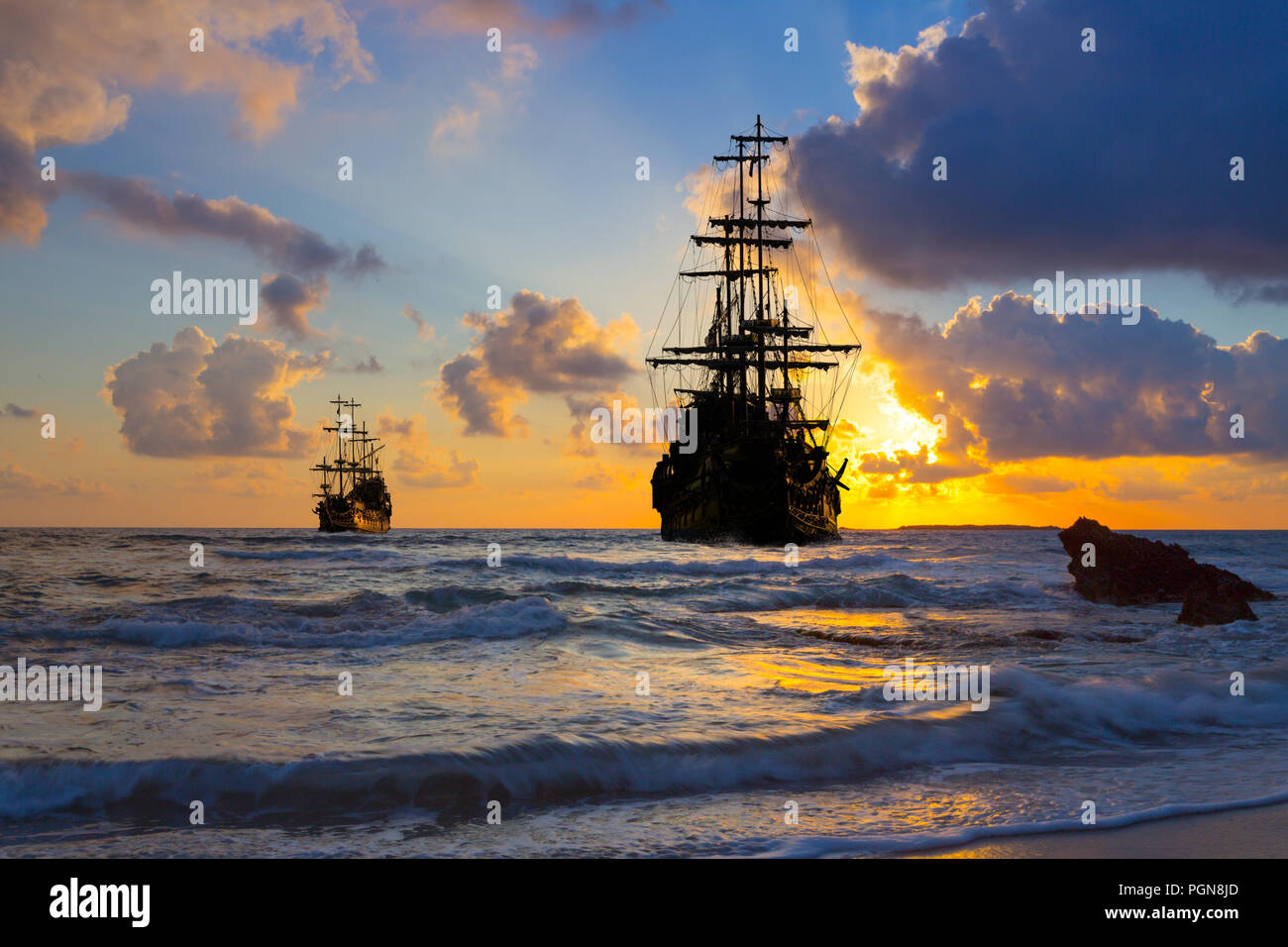 Old ship silhouette in sunset scenery Stock Photo - Alamy