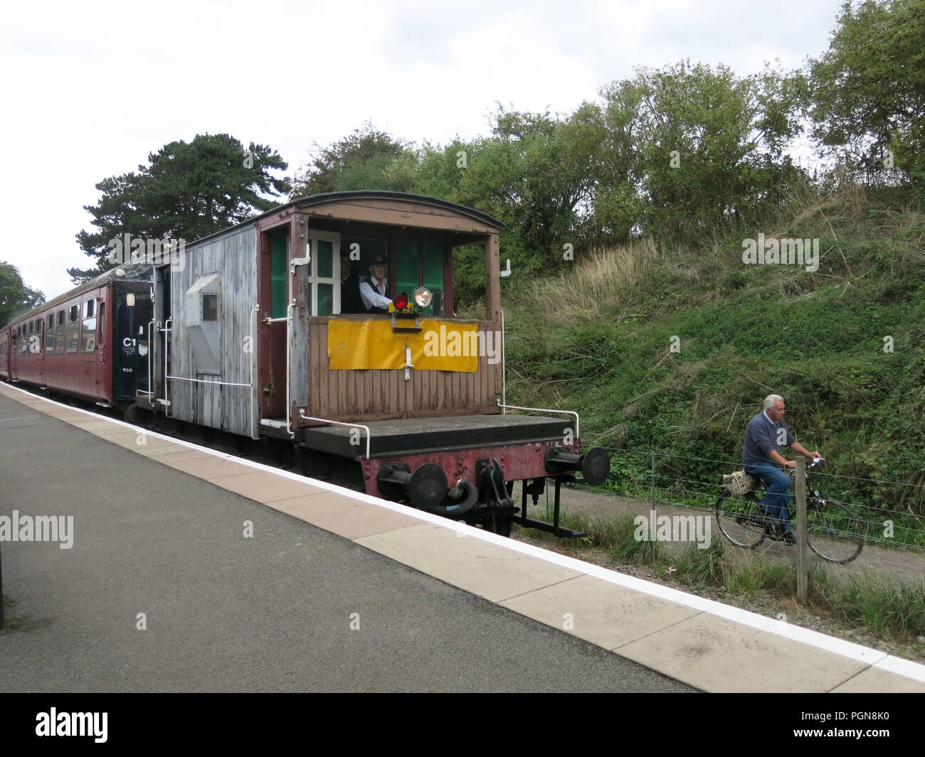 A cyclist rides along the Brampton Valley Way alongside an engine from ...