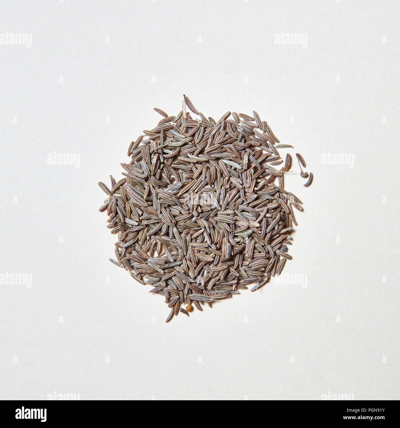 A round pattern of natural herb cumin seeds isolated on white ...