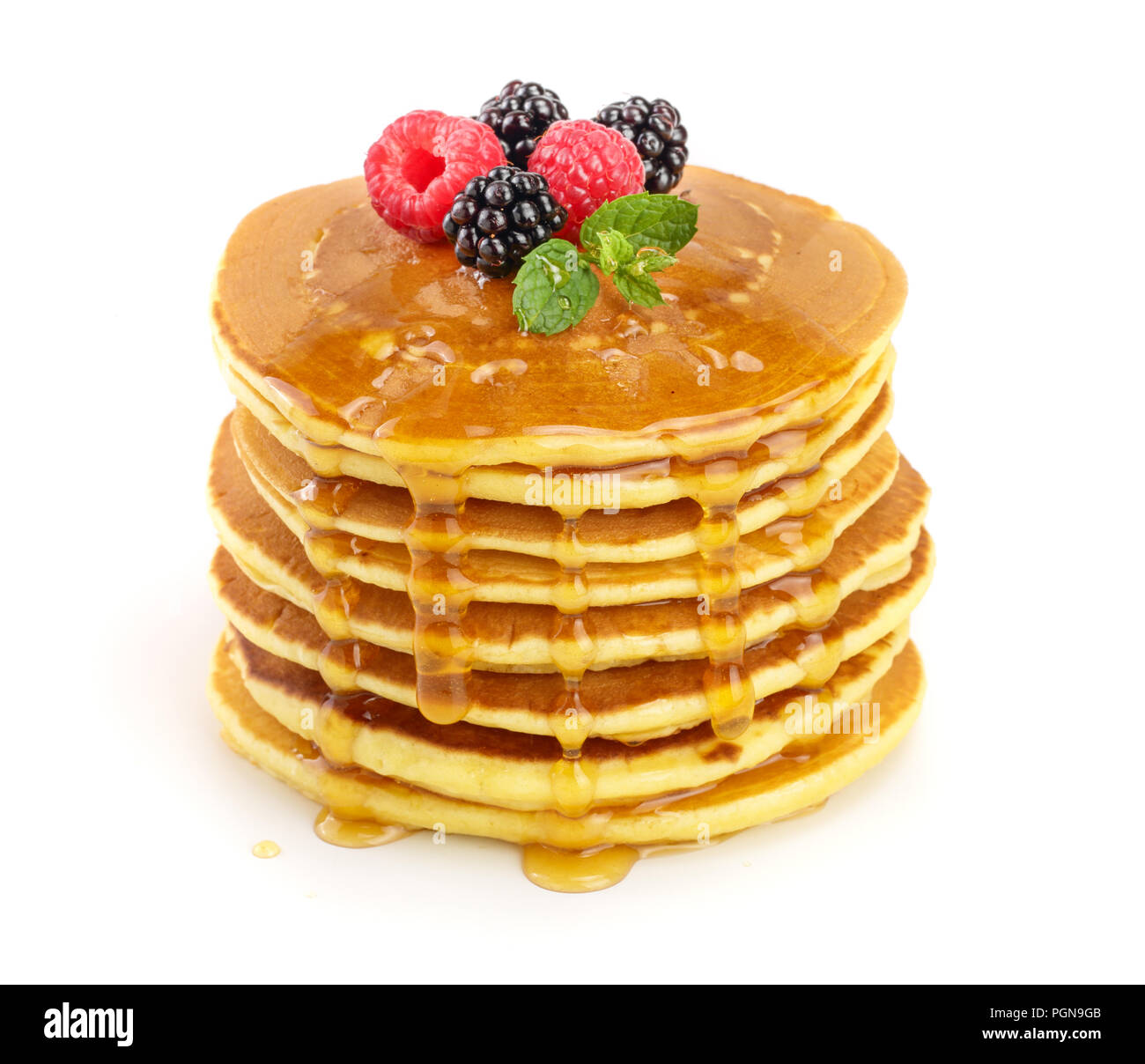Pancakes stack with different berries and honey isolated on white ...