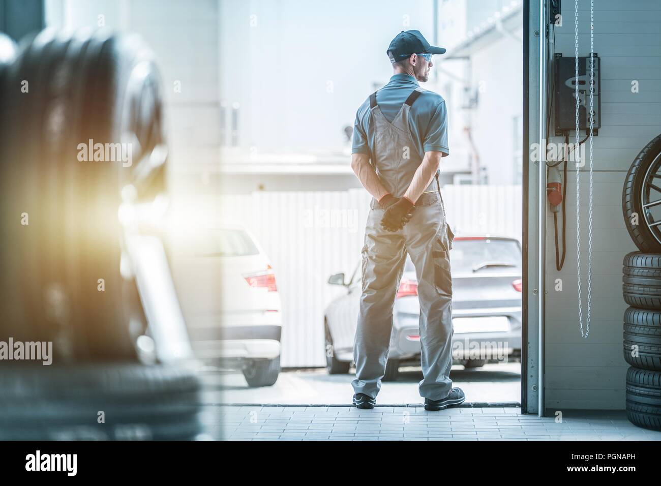 Caucasian Auto Service Worker Waiting For Clients Standing in the ...