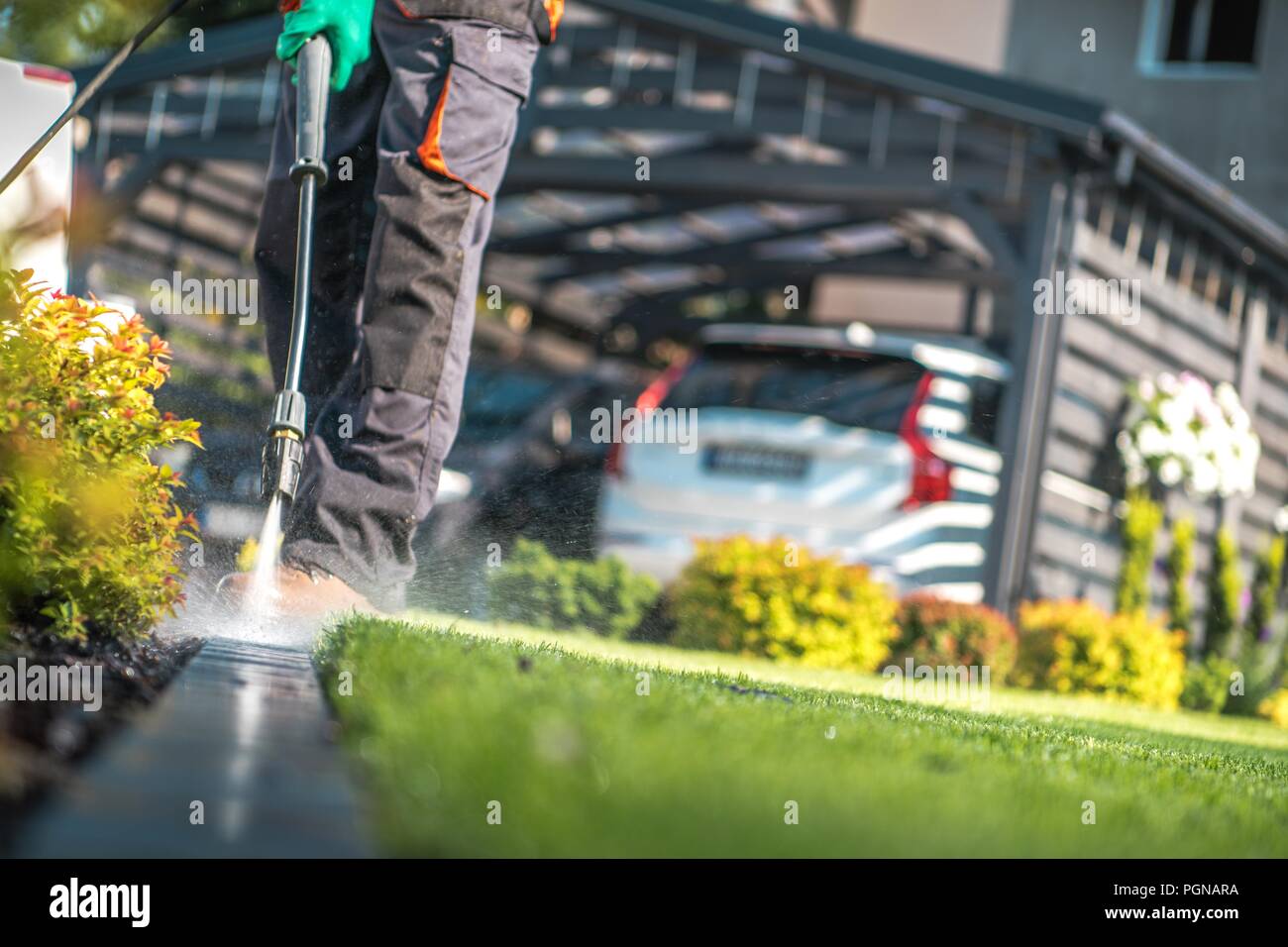 Garden Cleaning Work with Powerful Pressure Washer. Cleaning Cobble ...