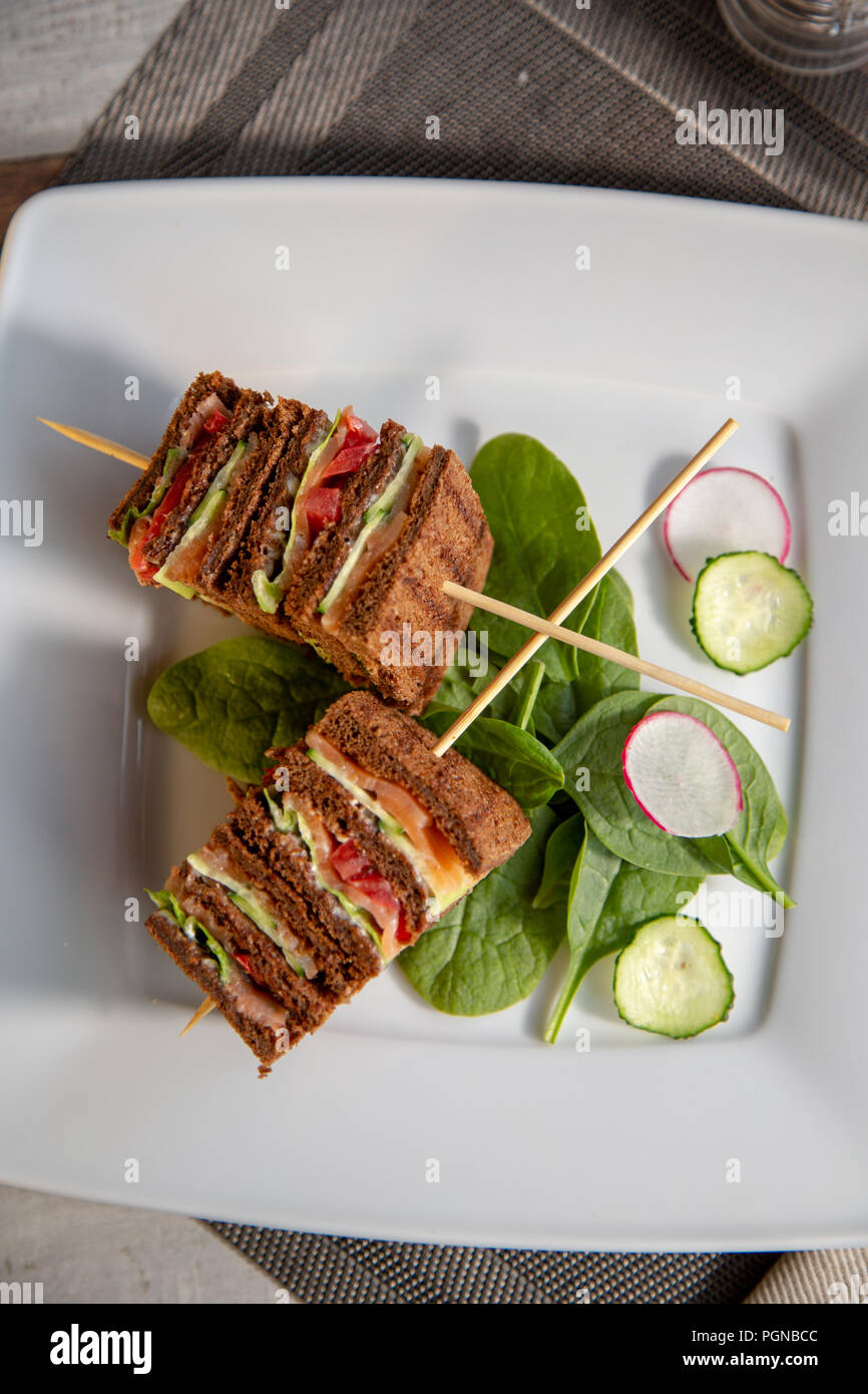 Club sandwich in a white plate. Meal time Stock Photo - Alamy