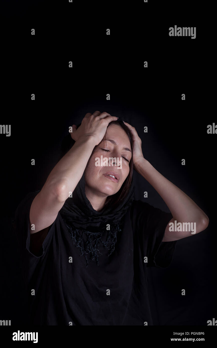 Studio shot of depressed woman over black background Stock Photo - Alamy