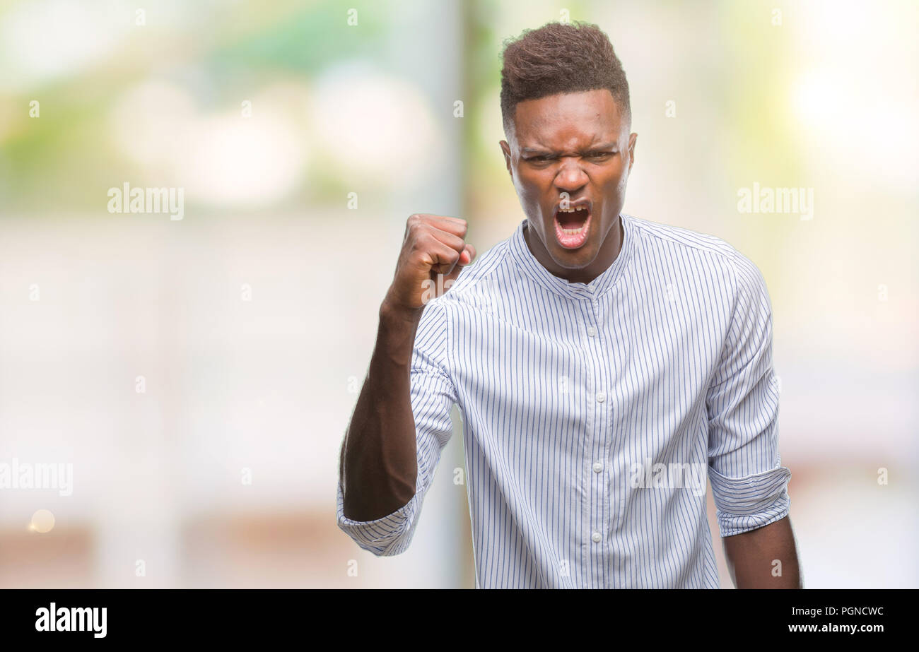Young african american man over isolated background angry and mad ...