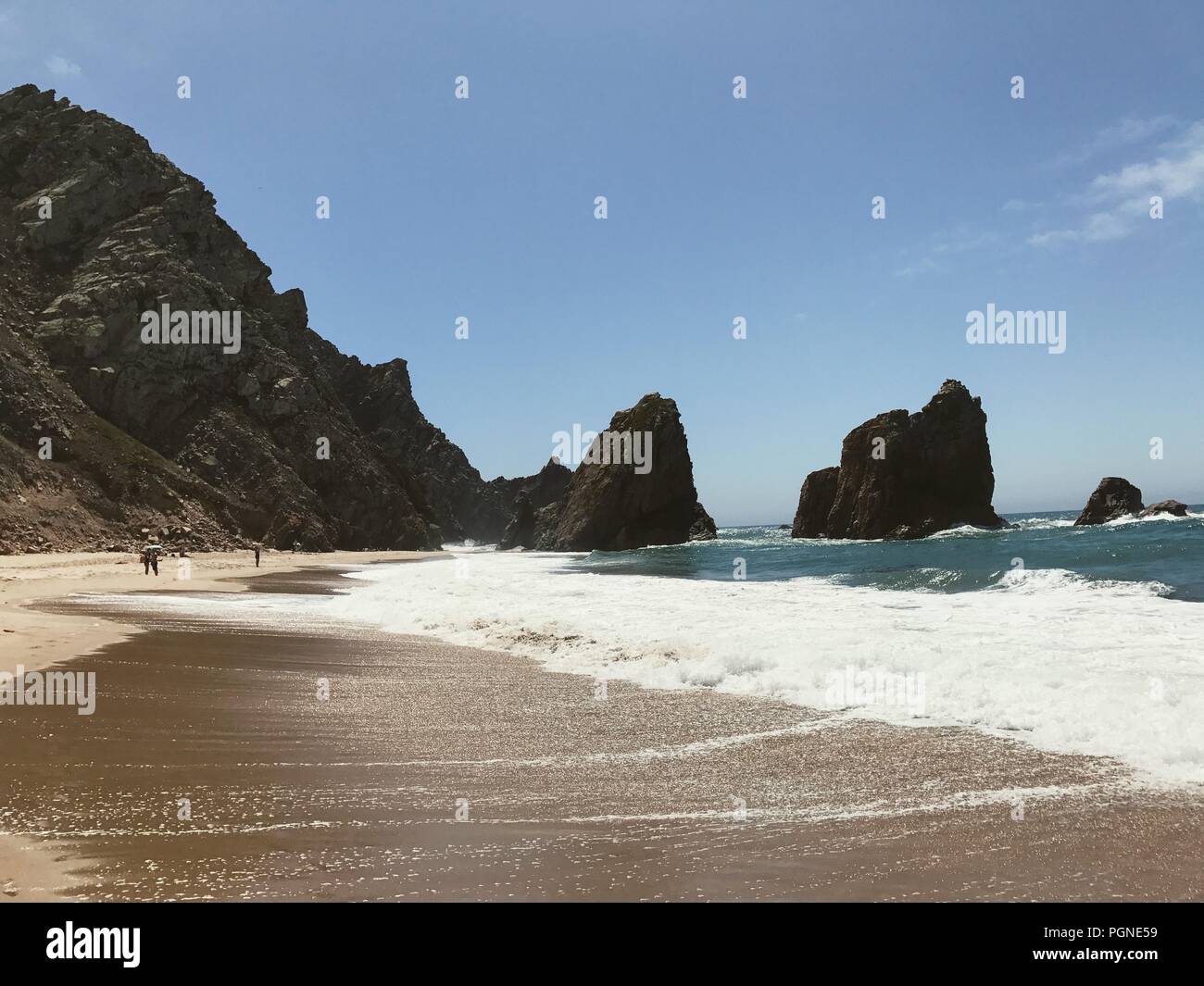 Atlantic ocean waves with golden sand in Praia da Ursa Portugal near ...