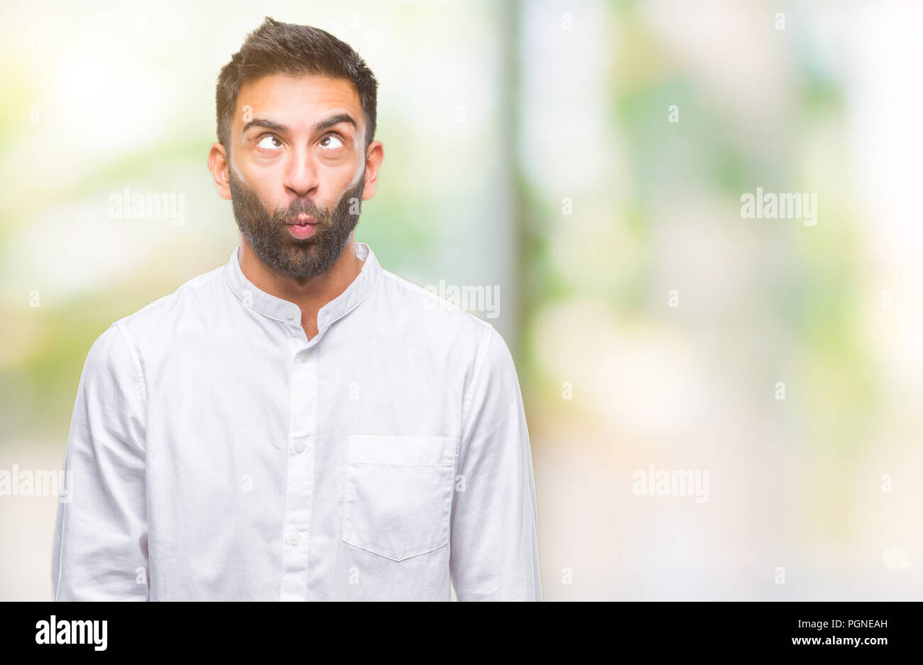Adult hispanic man over isolated background making fish face with lips ...