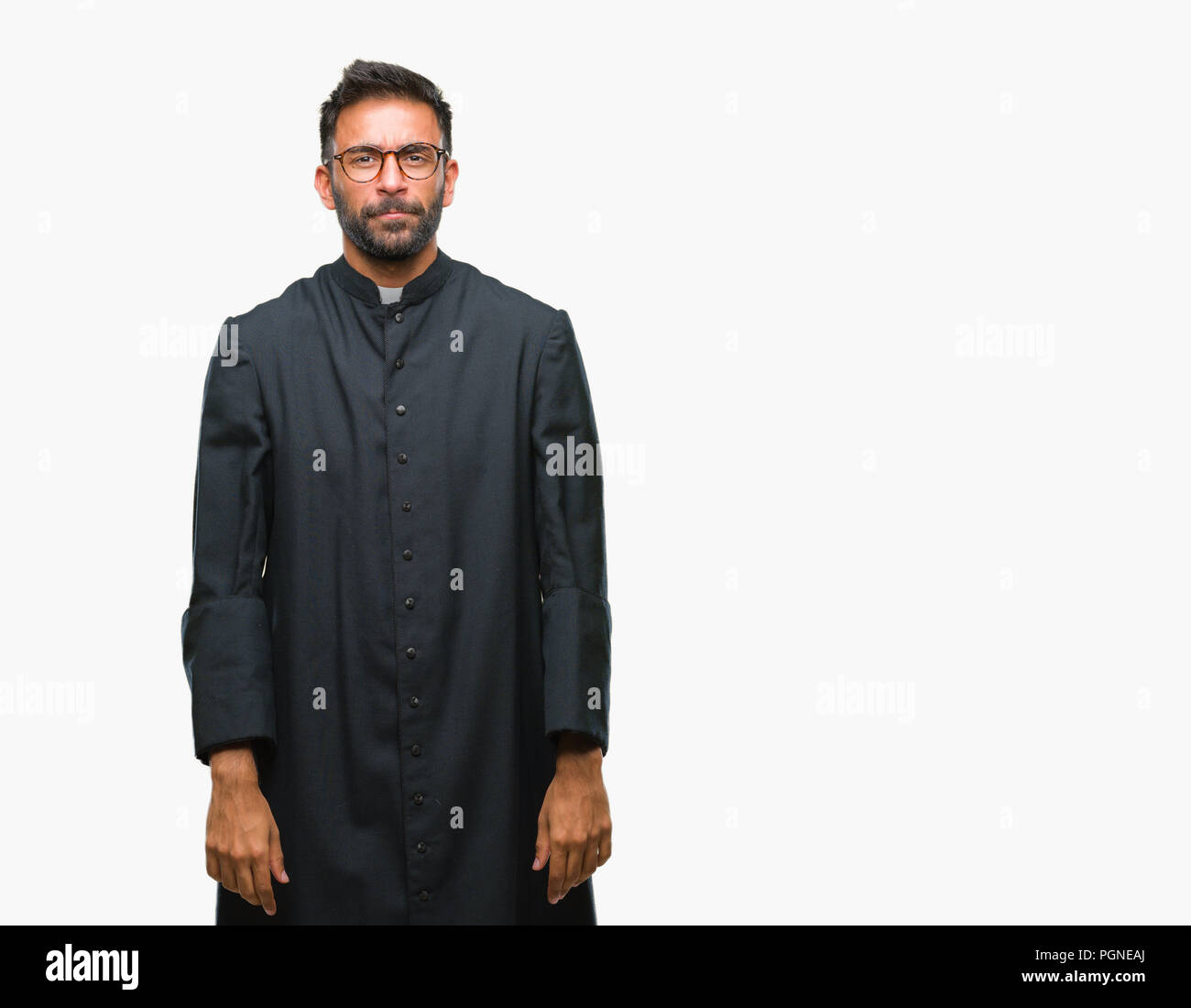 Adult hispanic catholic priest man over isolated background depressed ...
